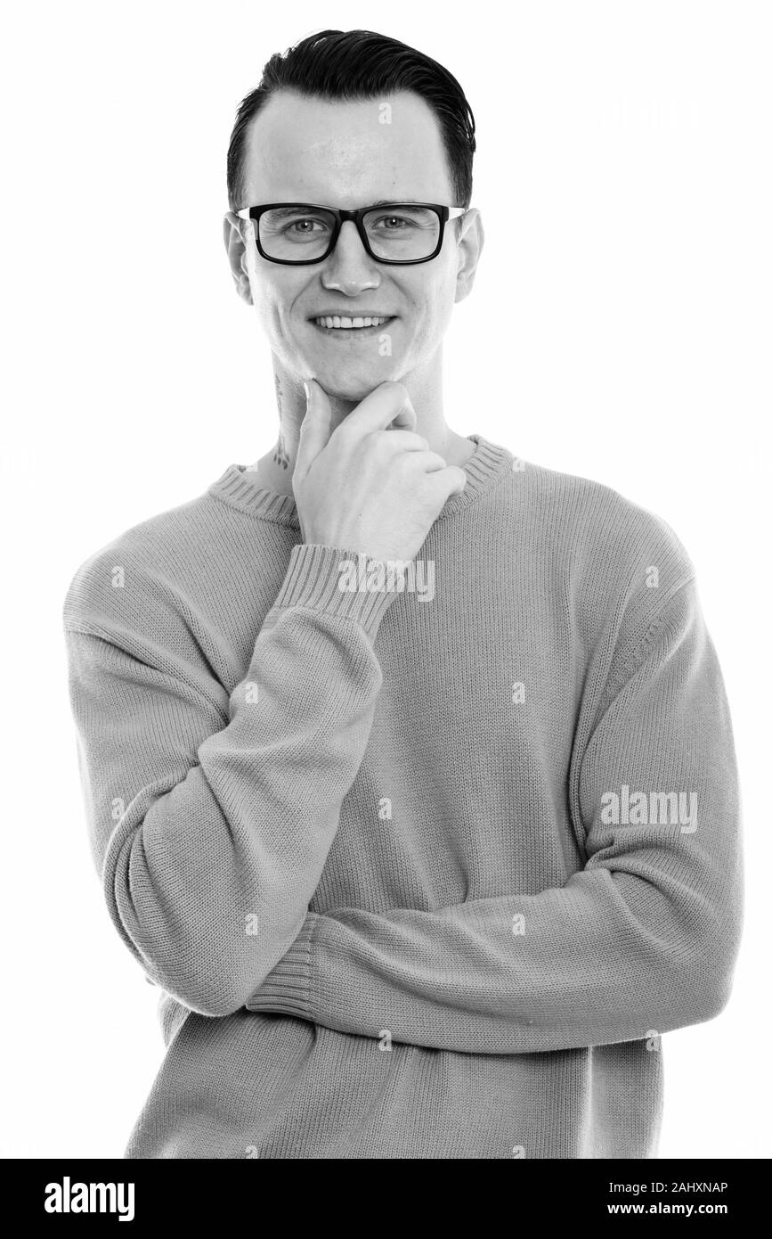 Happy young handsome man smiling while thinking Stock Photo - Alamy