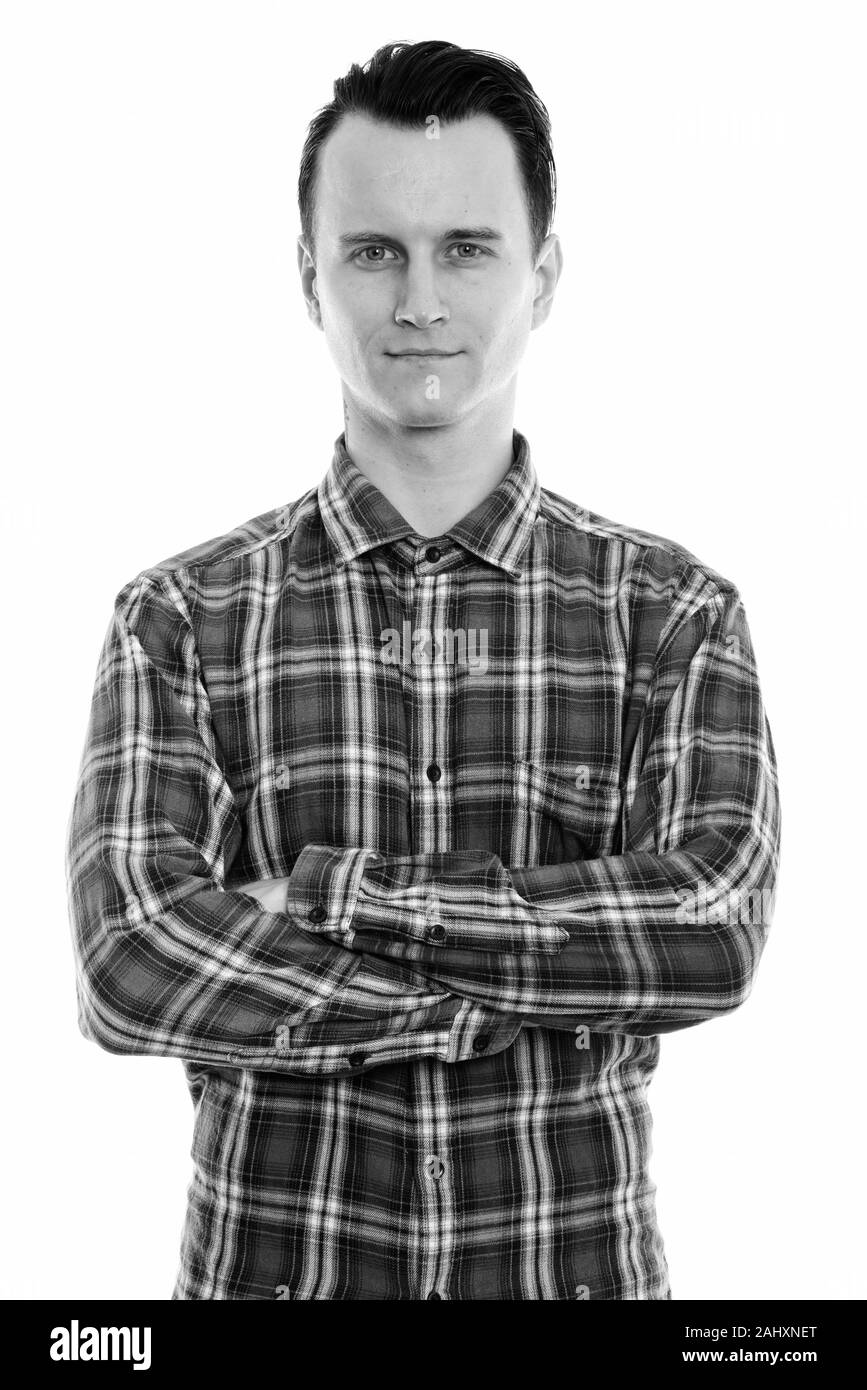 Studio shot of young handsome man with arms crossed Stock Photo - Alamy
