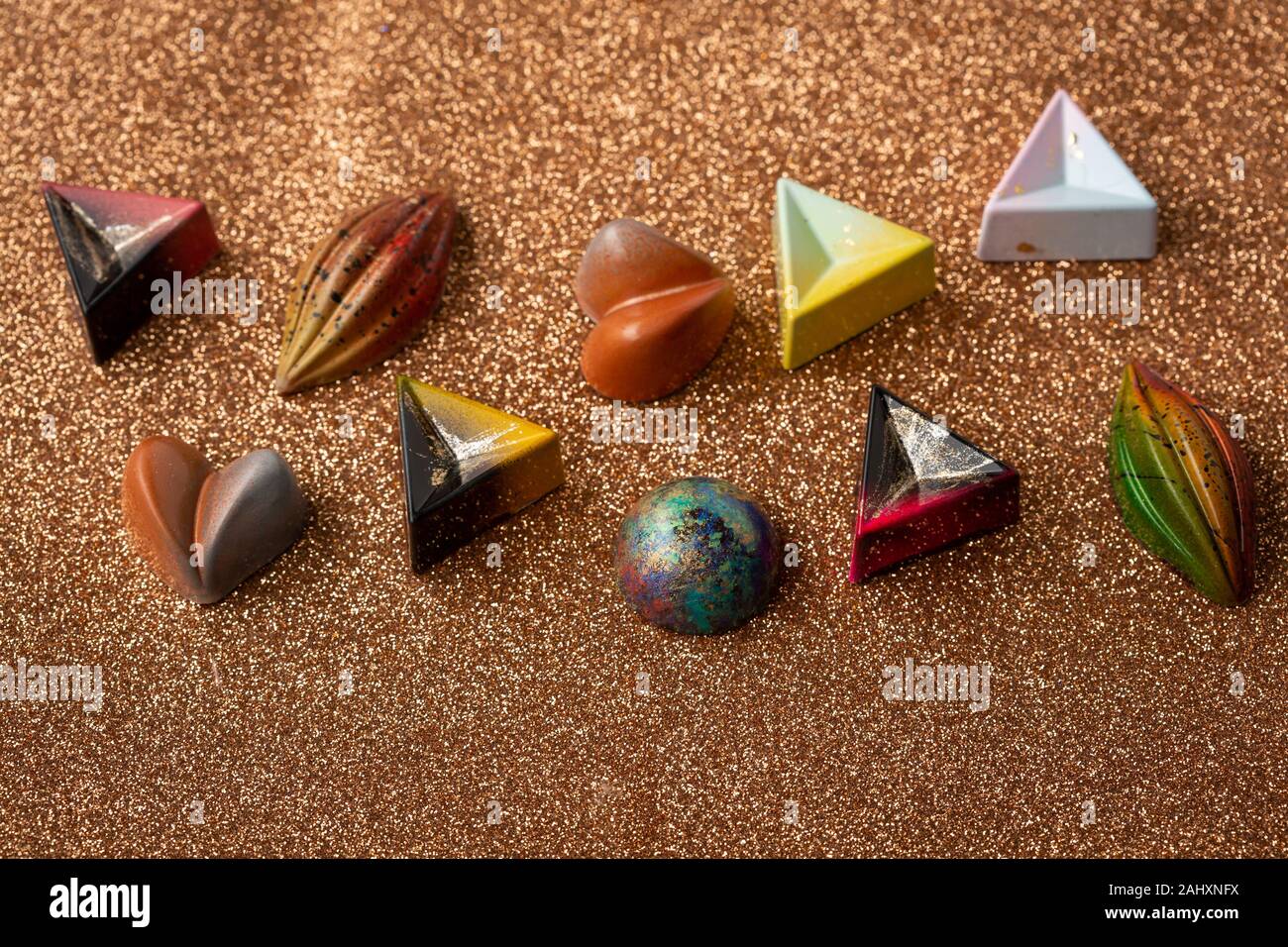 Sweet chocolate candy mix on yellow background Stock Photo - Alamy