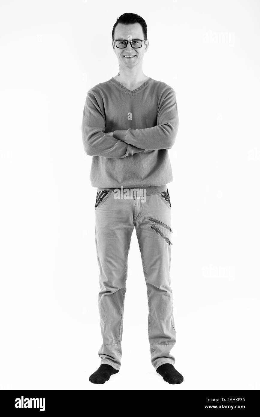 Full body shot of young happy man smiling and wearing eyeglasses with ...