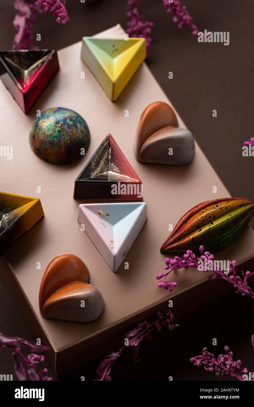 Sweet chocolate candy mix on brown box background Stock Photo - Alamy