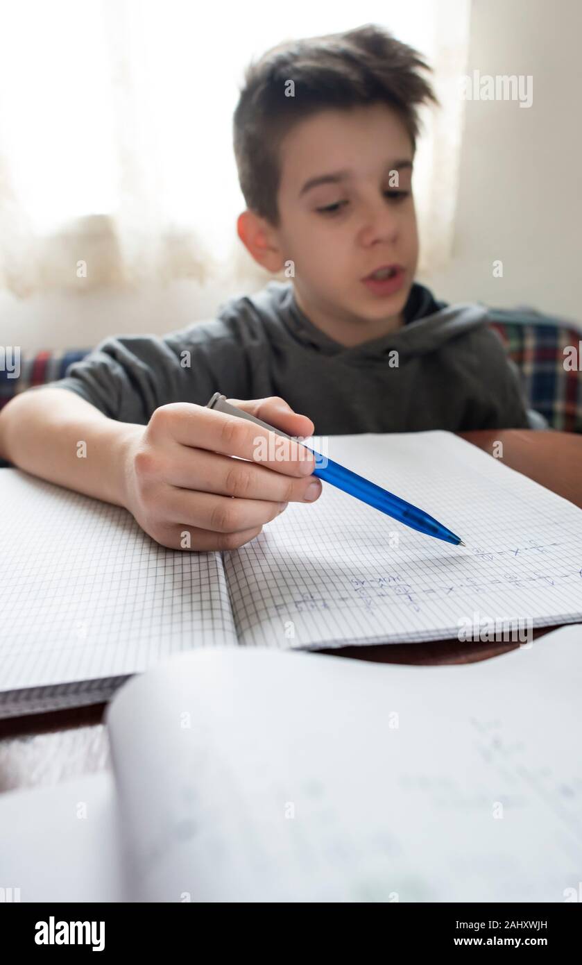 Boy do his homework. Notebook Stock Photo - Alamy