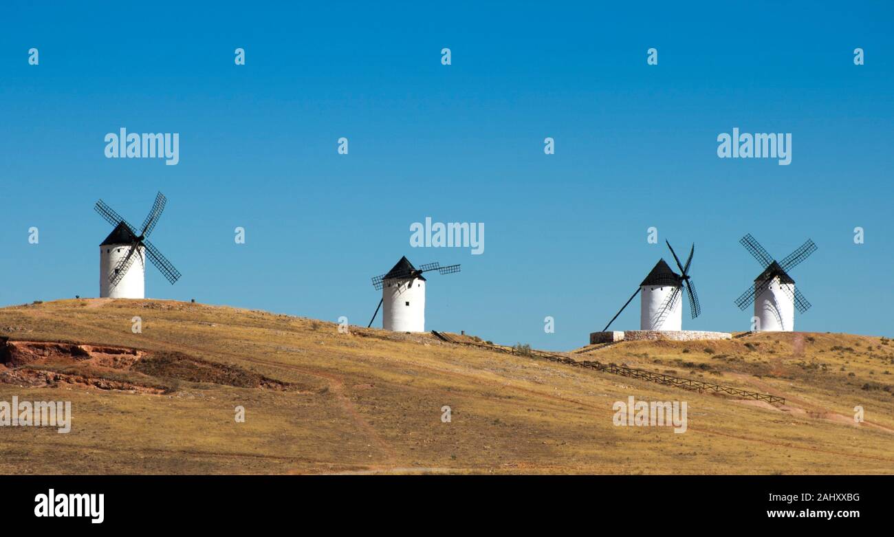 White ancient windmills. Blue sky background Stock Photo - Alamy
