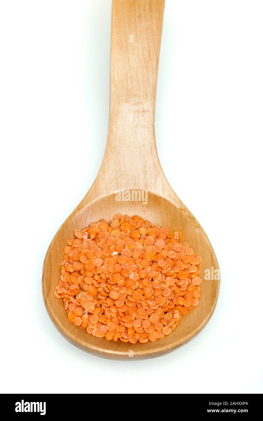 Lentil split in wooden spoon on white background Stock Photo - Alamy