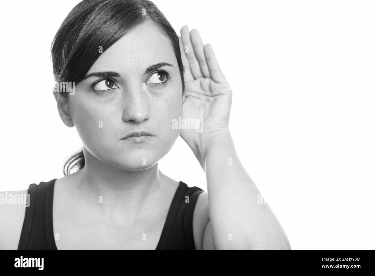 Studio shot of beautiful woman listening in black and white Stock Photo ...