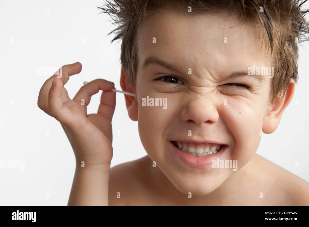 Boy cleans his ear. Isolated white background Stock Photo - Alamy