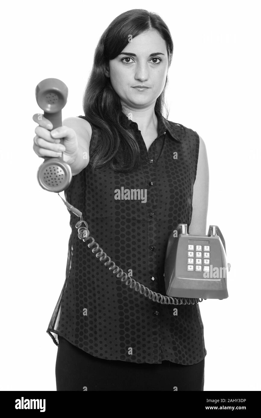 Studio shot of beautiful woman giving old telephone Stock Photo - Alamy