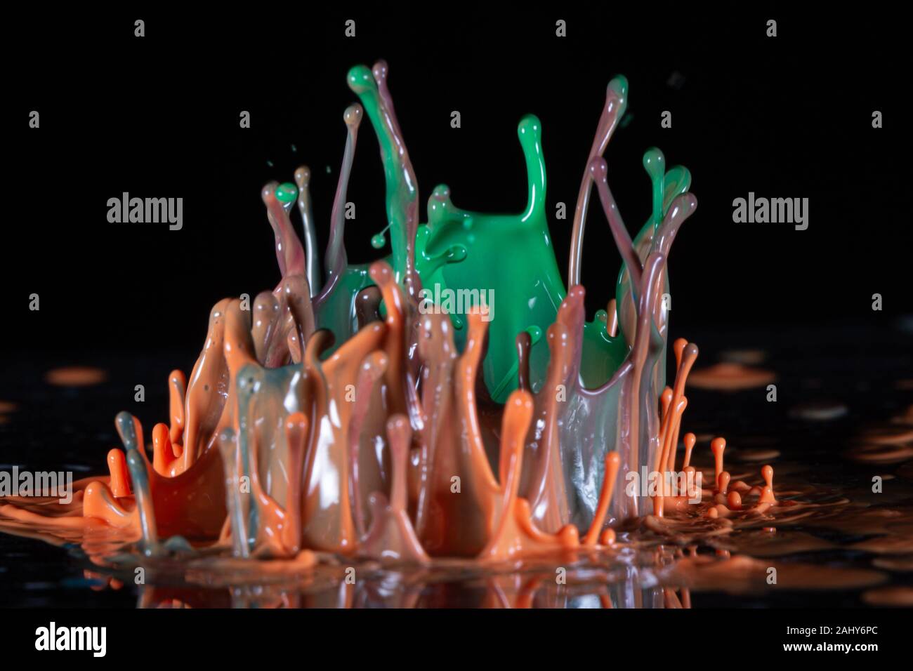 orange ink splash on a black background Stock Photo - Alamy