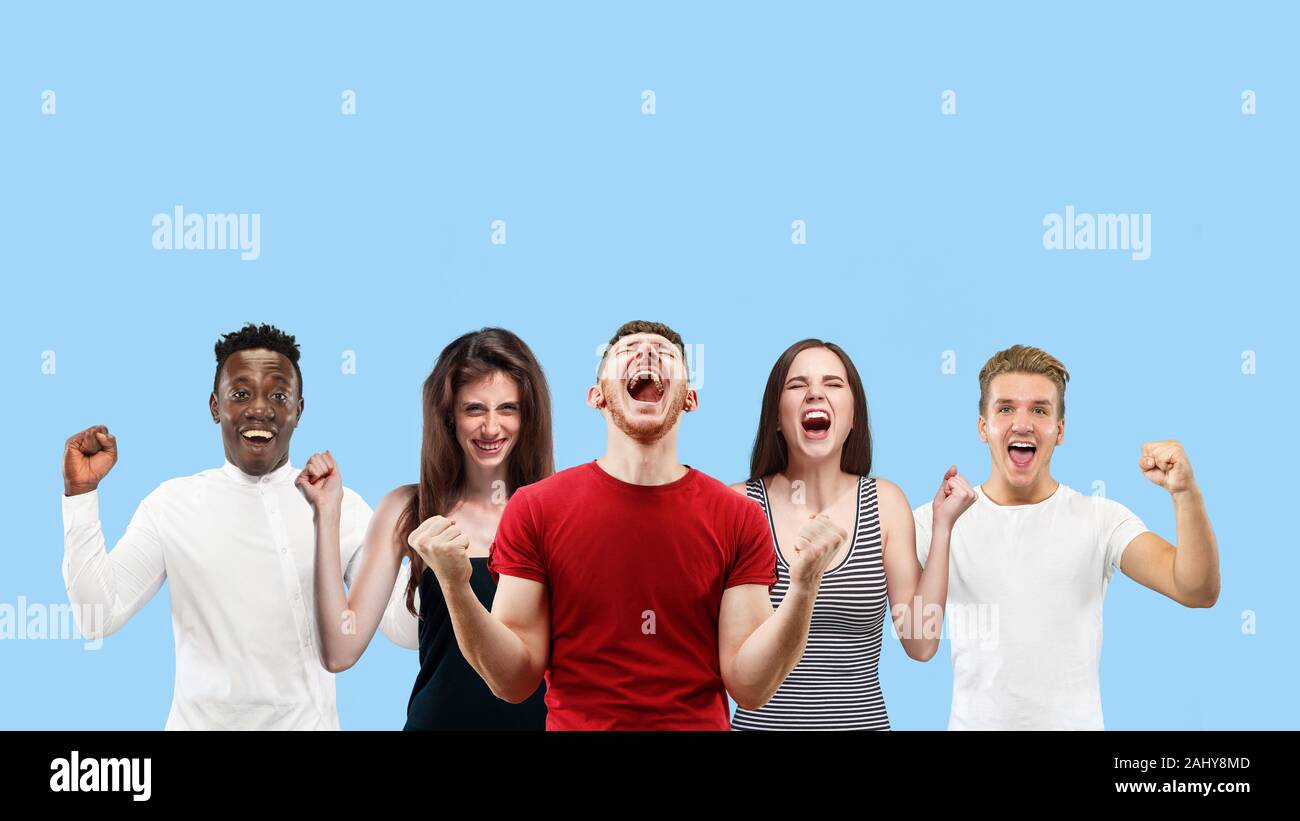 Portrait of multiethnic group of young people isolated on blue studio ...