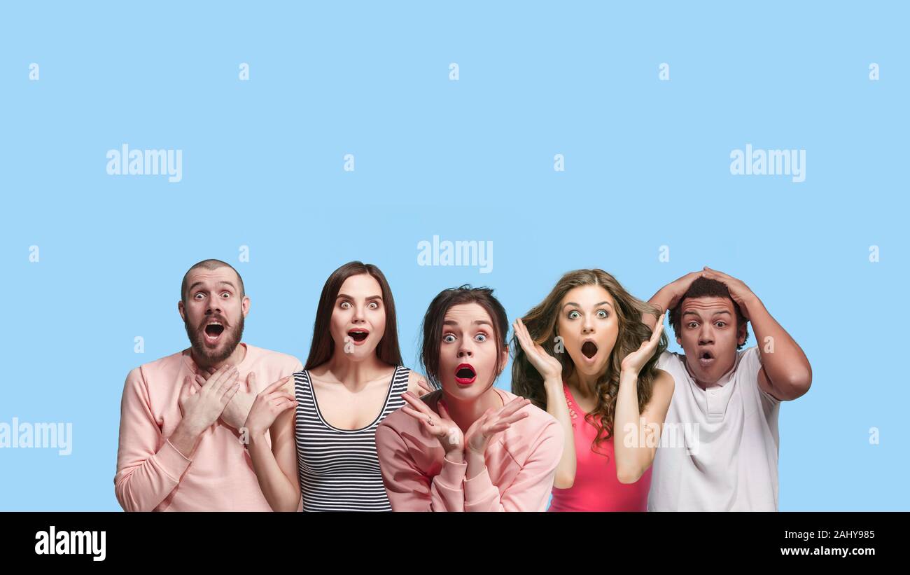 Portrait of multiethnic group of young people isolated on blue studio ...