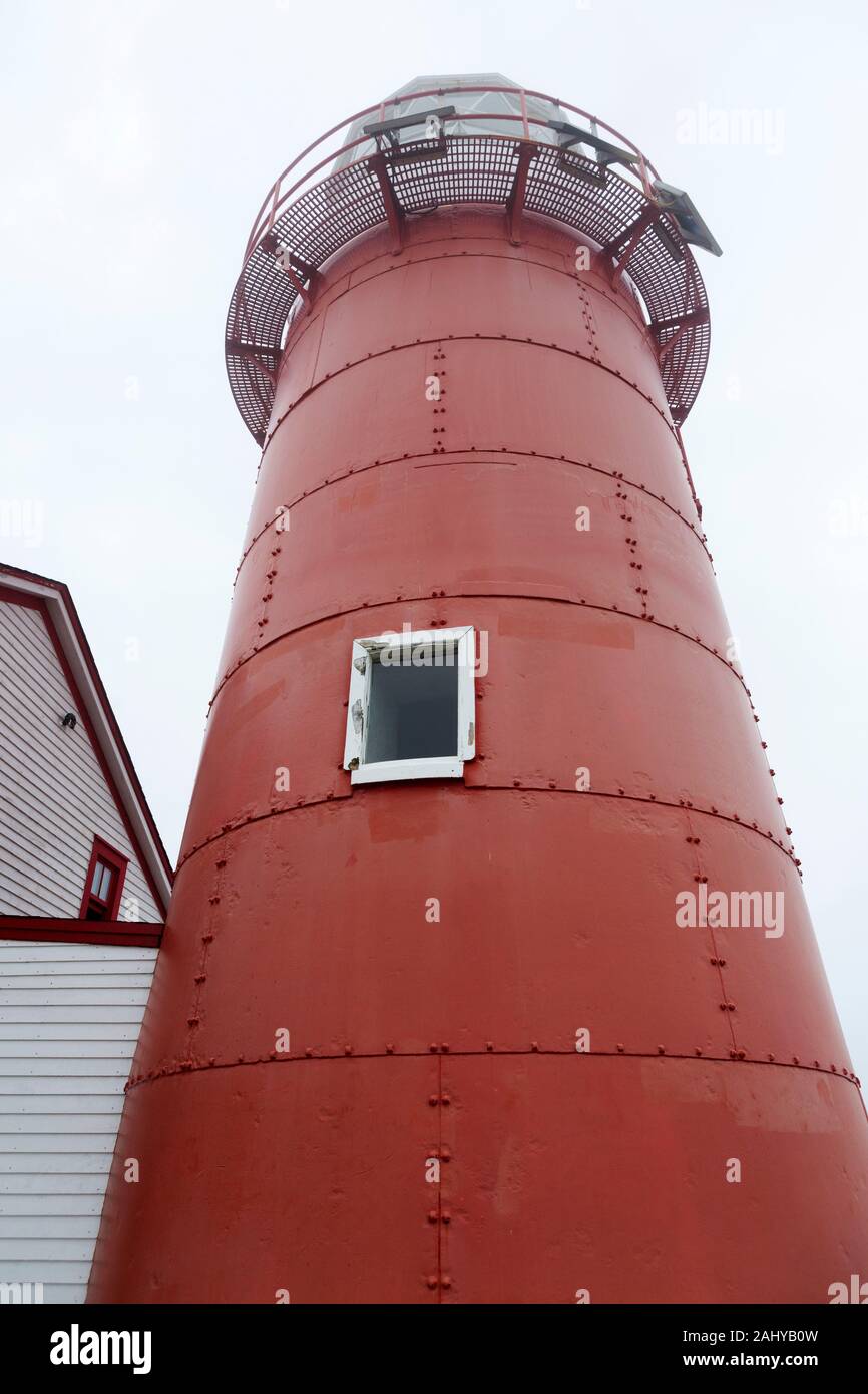 The red tower of the Ferryland Lighthouse on a foggy day in ...
