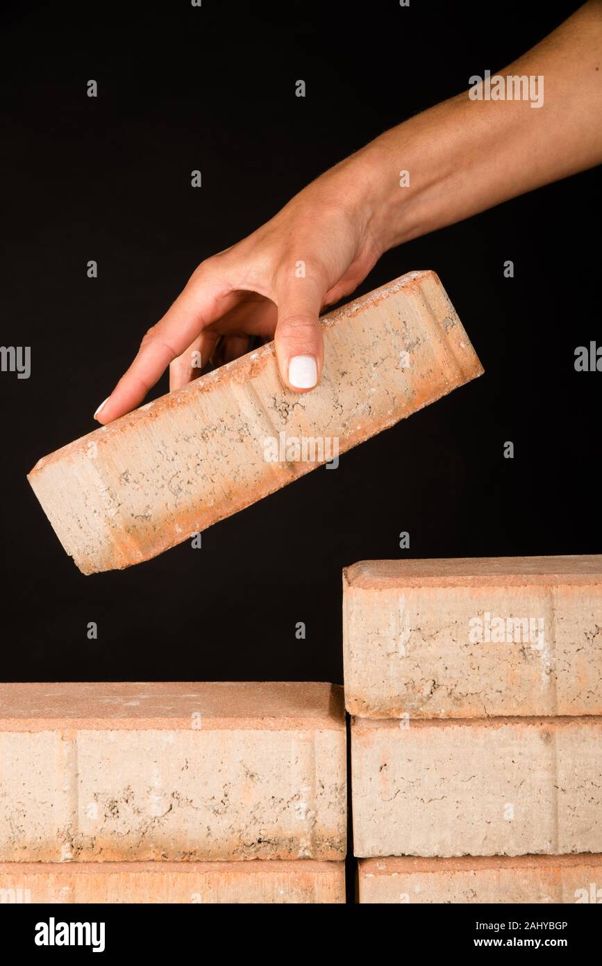 Female hand building a wall, an immigration concept Stock Photo - Alamy