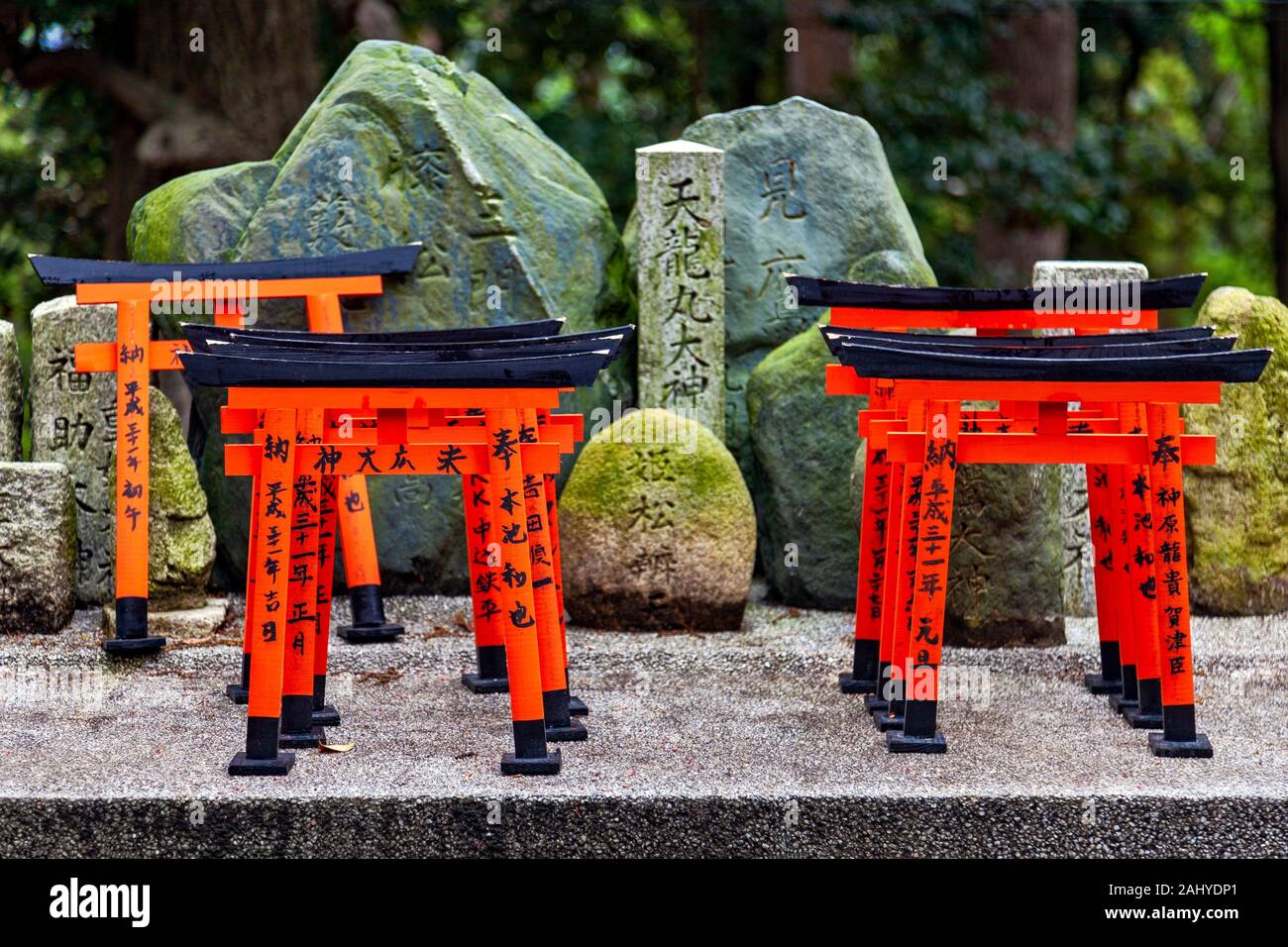 Mini torri gates on a stone plinth at the Okusha Hohaisho Shrine in the ...
