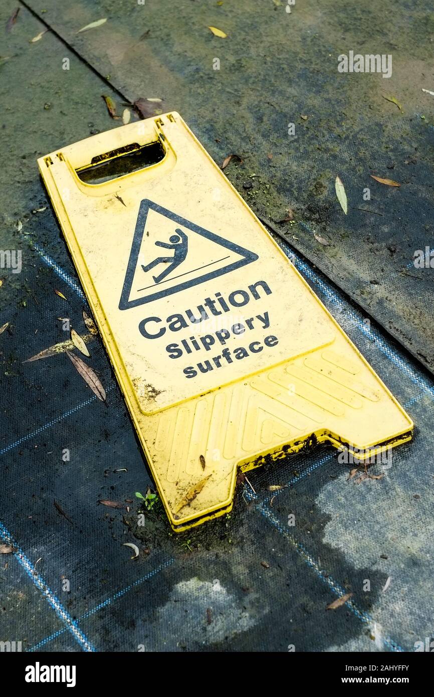 A plastic caution sign lying on the ground Stock Photo - Alamy