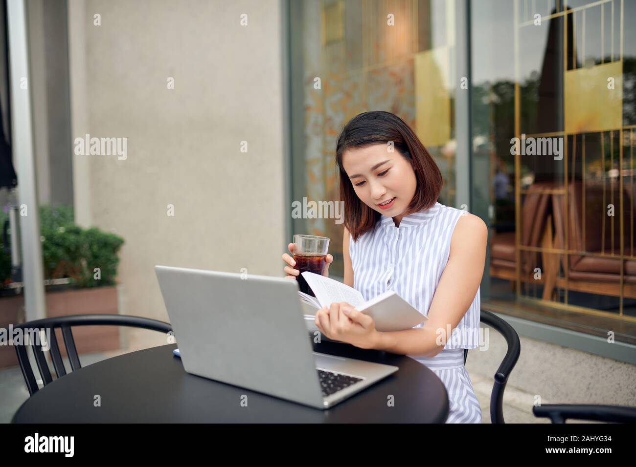 Beautiful girl reading a book in coffee shop Stock Photo - Alamy