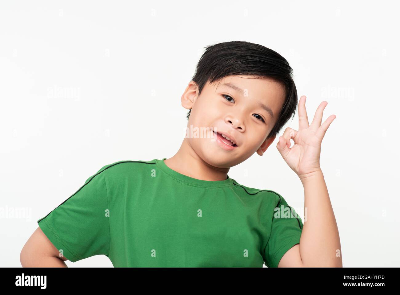 Cute boy showing ok sign, smiling positive, white studio background ...