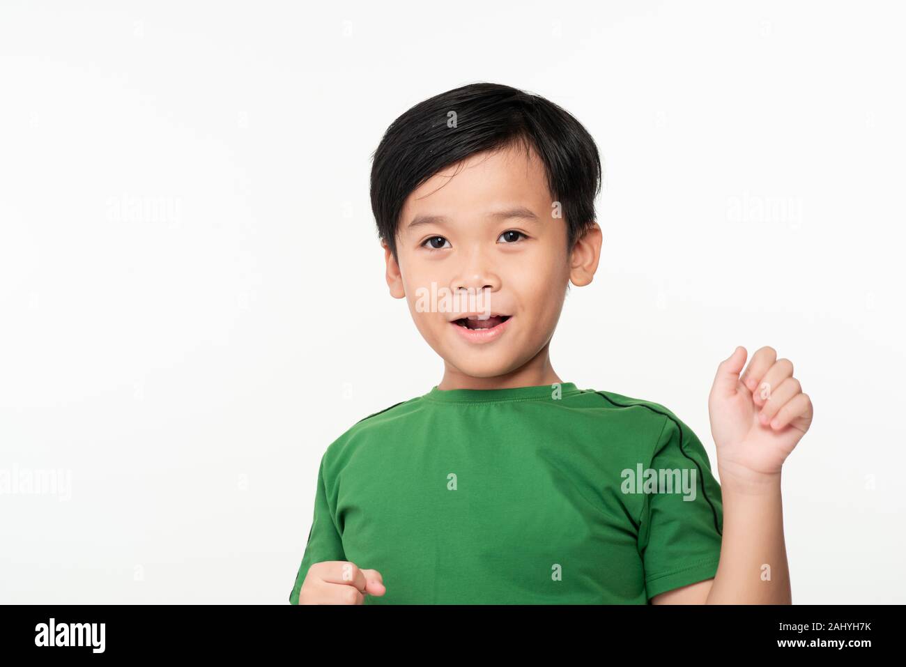 Portrait of cute smart young Asian boy shows winning gesture and ...