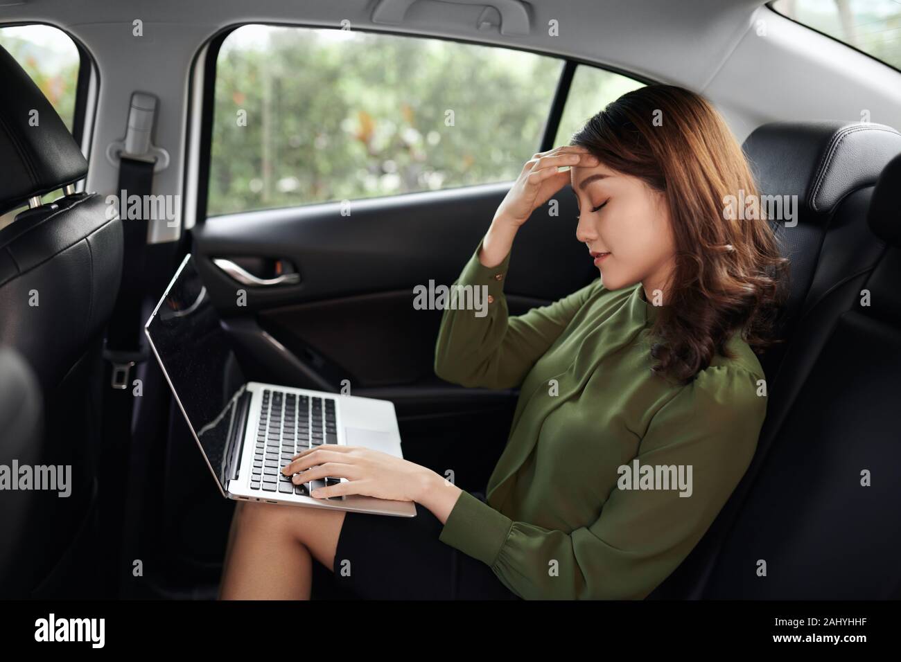 Asian woman bored stress work using laptop computer while sitting in ...