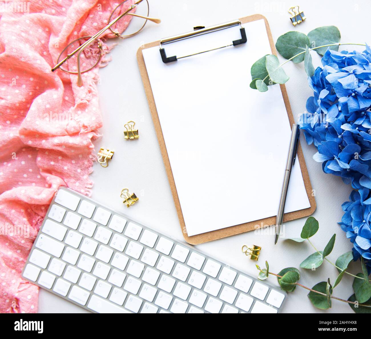 Home office desk workspace with blank paper clipboard and blue ...