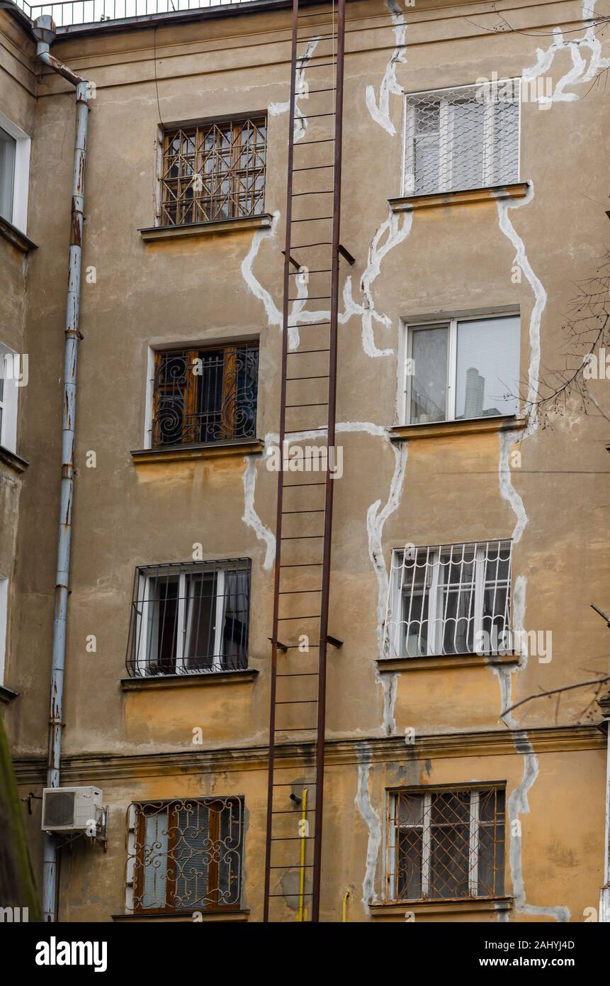Facade of an old apartment building with repaired cracks. External ...