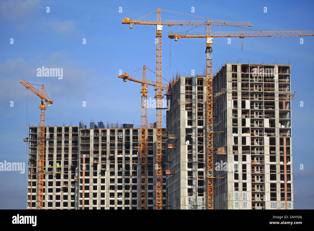 High-rise construction cranes and array of buildings under construction ...