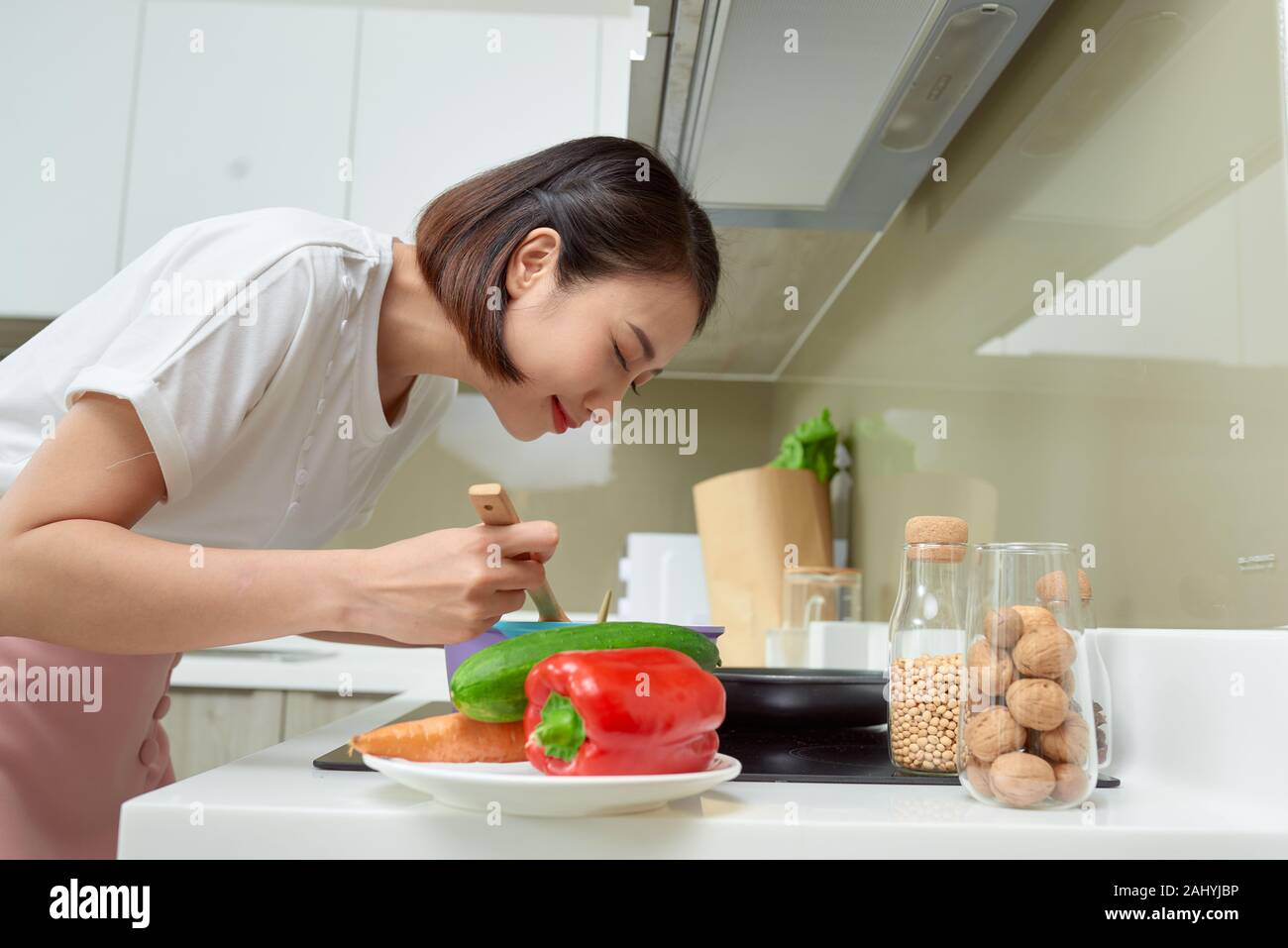 Young Woman Cooking in the kitchen. Healthy Food. Dieting Concept ...