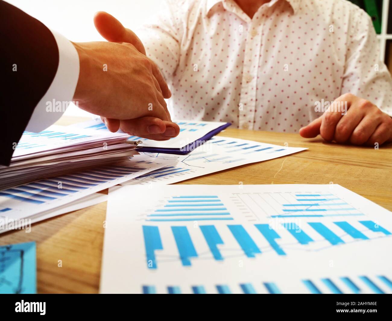 Businessmen shake hands in the office. Business success. The conclusion ...