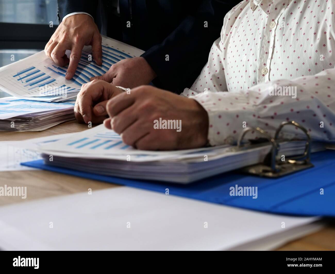 The boss explains to the employee. The manager shows financial ...