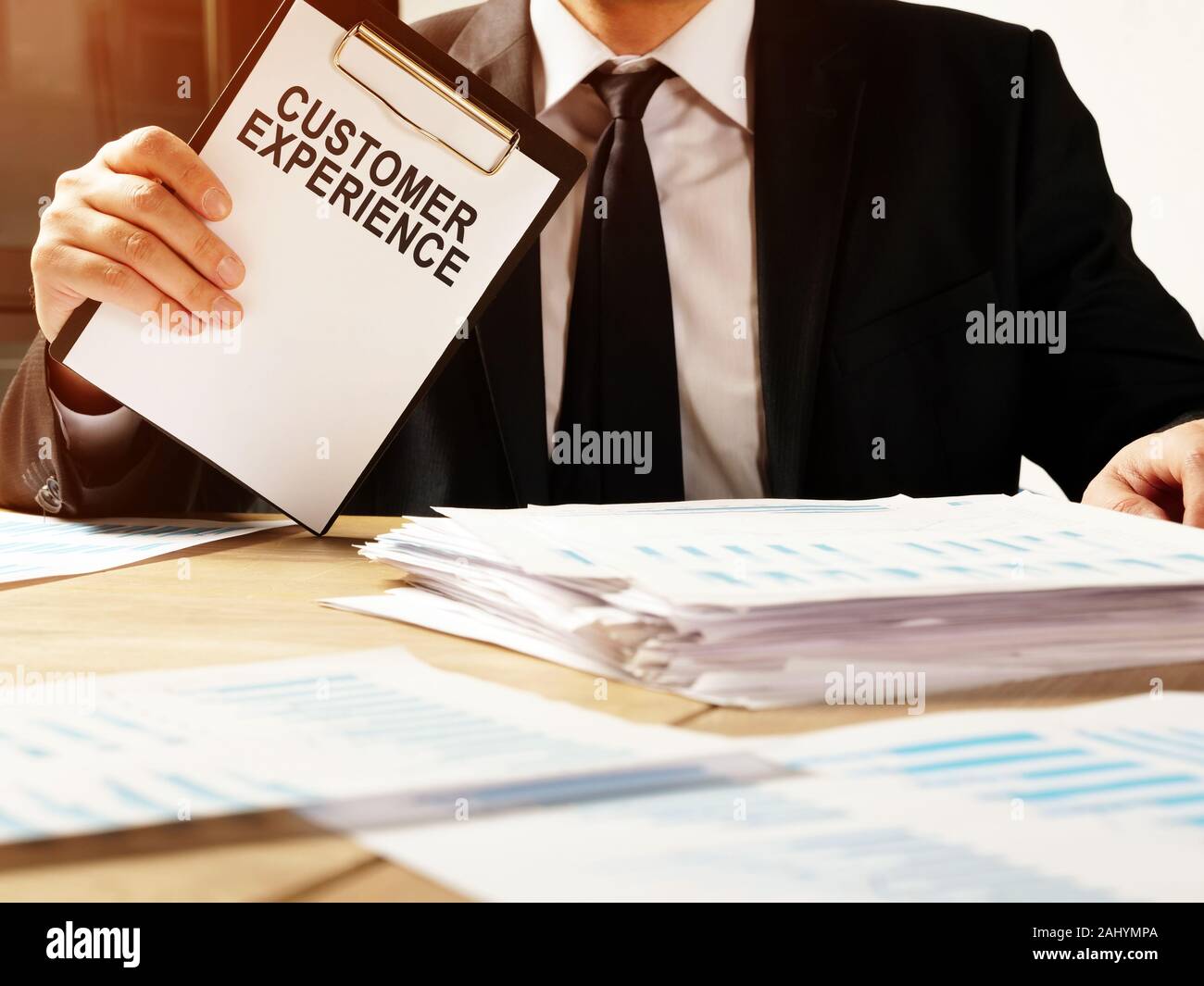 Customer experience report and stack of papers Stock Photo - Alamy