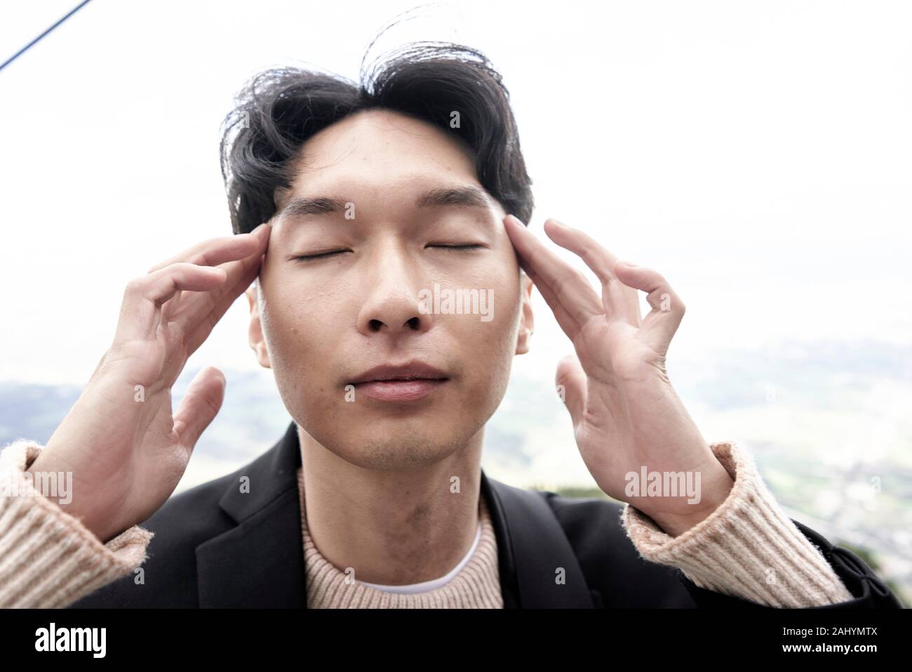 Korean man concentrating Stock Photo - Alamy