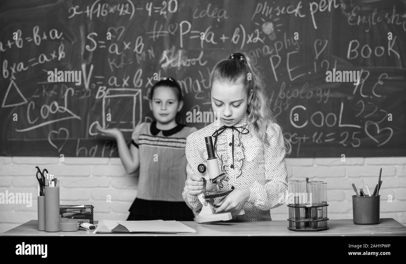 Little scientist work with microscope. Little girls in school lab ...