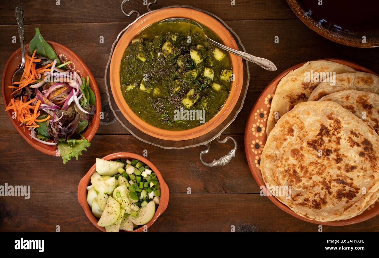 Saag Aloo- Indian potato and spinach burry served with flaky layered ...