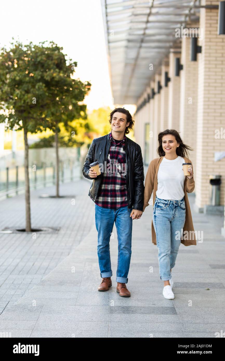 Two People Walking Down The Street