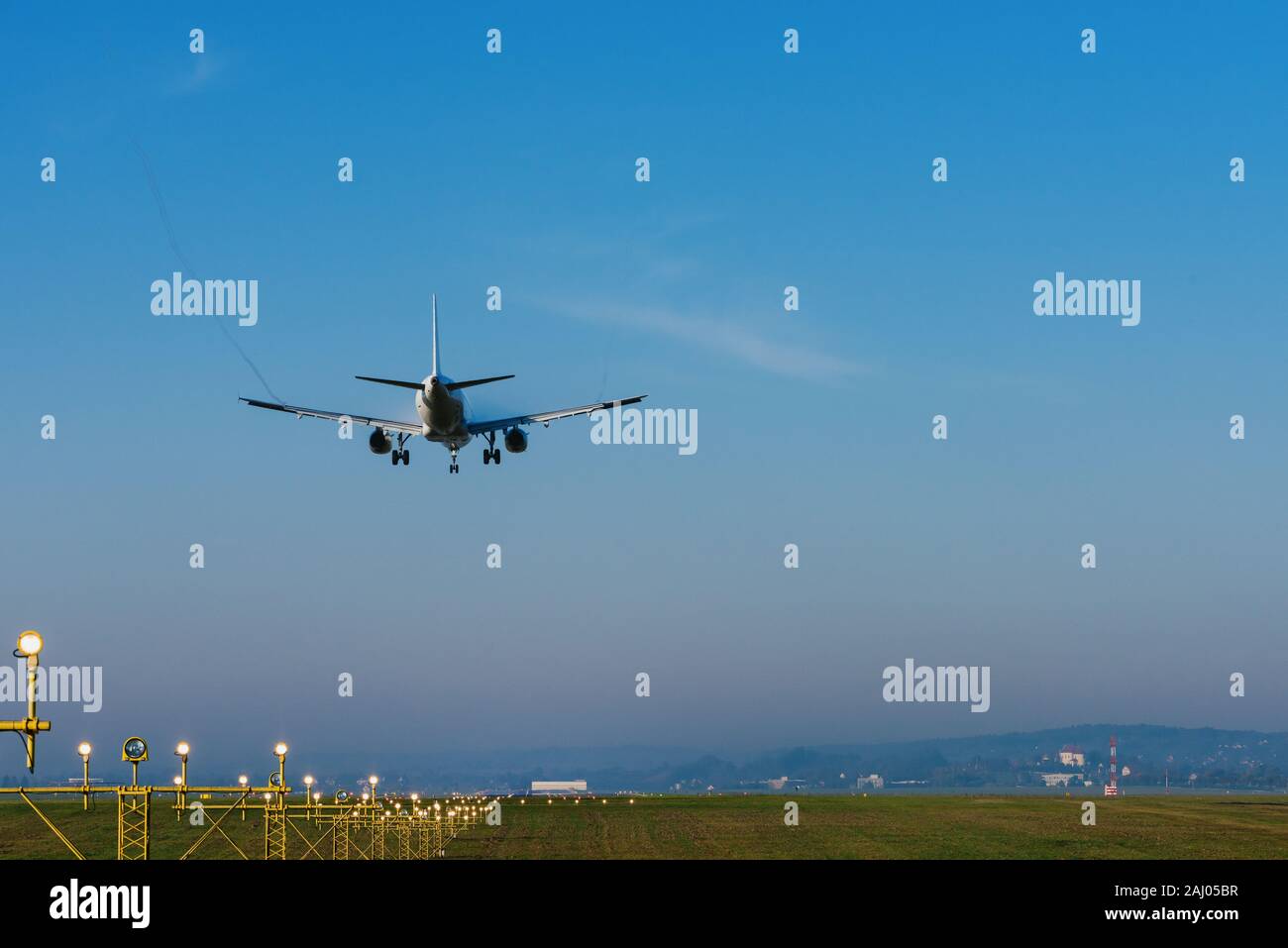 Passenger plane landing on airport runway Stock Photo - Alamy