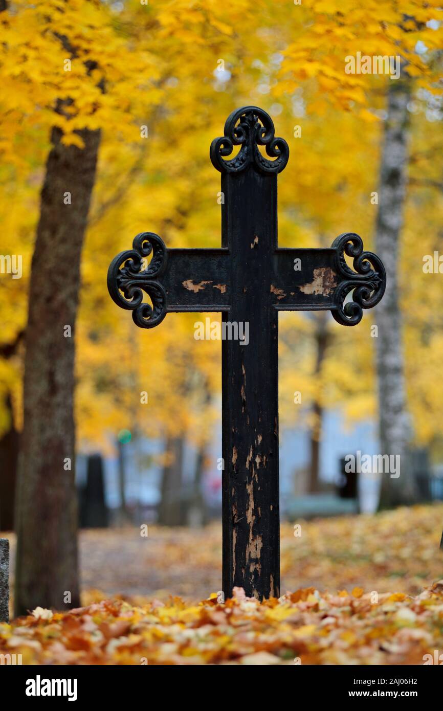 An old memorial on an ancient graveyard with beautiful yellow maple ...