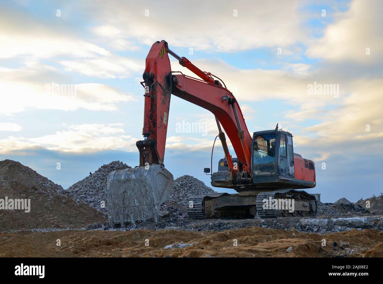Excavator loads of stone and rubble for processing into cement or ...