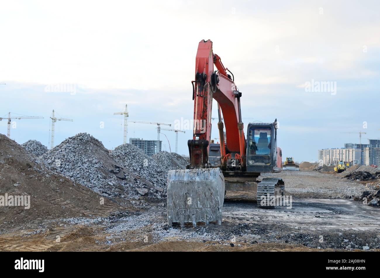 Excavator loads of stone and rubble for processing into cement or ...