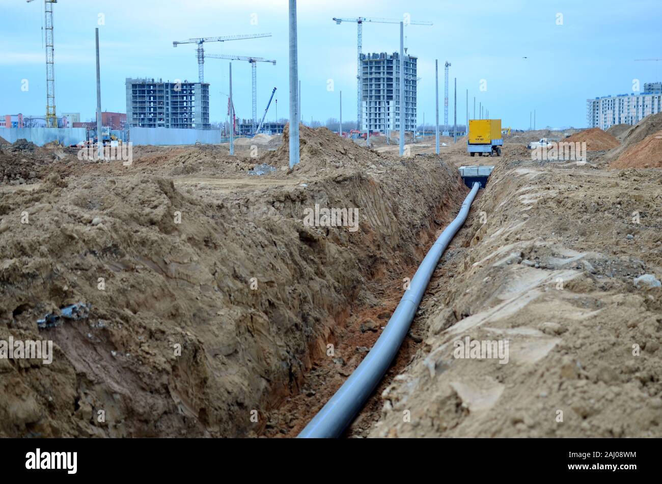 Laying of underground storm sewer pipes. Installation of water main ...