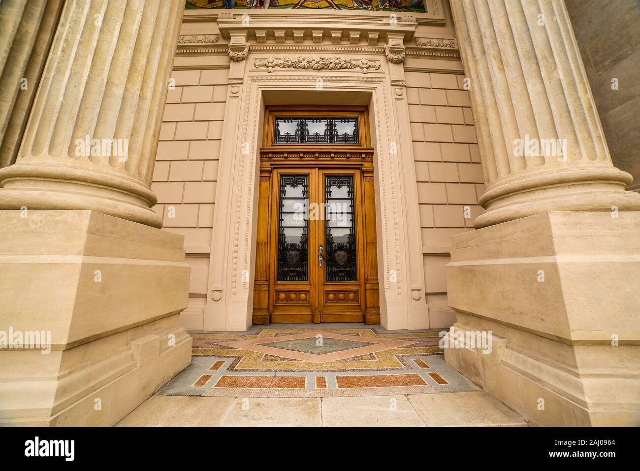 Massive and beautiful ancient roman columns with wooden door ...