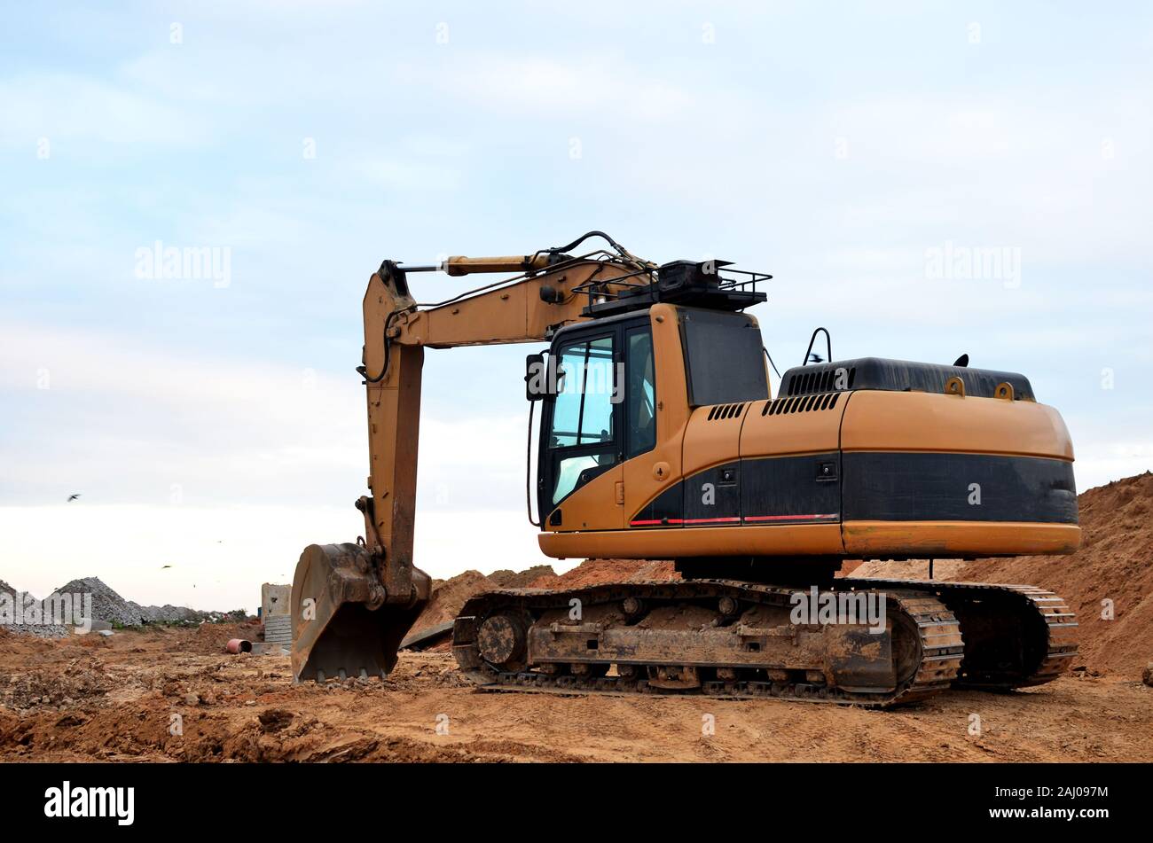Excavator digs the ground for the foundation and construction of a new ...