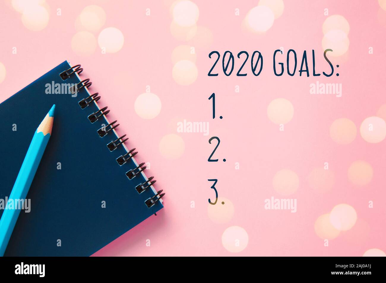 Dark blue notebook, a blue pensil on trendy pink background. Concept of ...