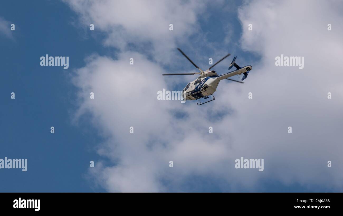 blue and white police helicopter flying in the sky Stock Photo - Alamy