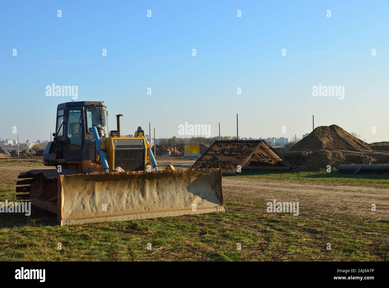 Bulldozer during of large construction jobs at building site. Land ...