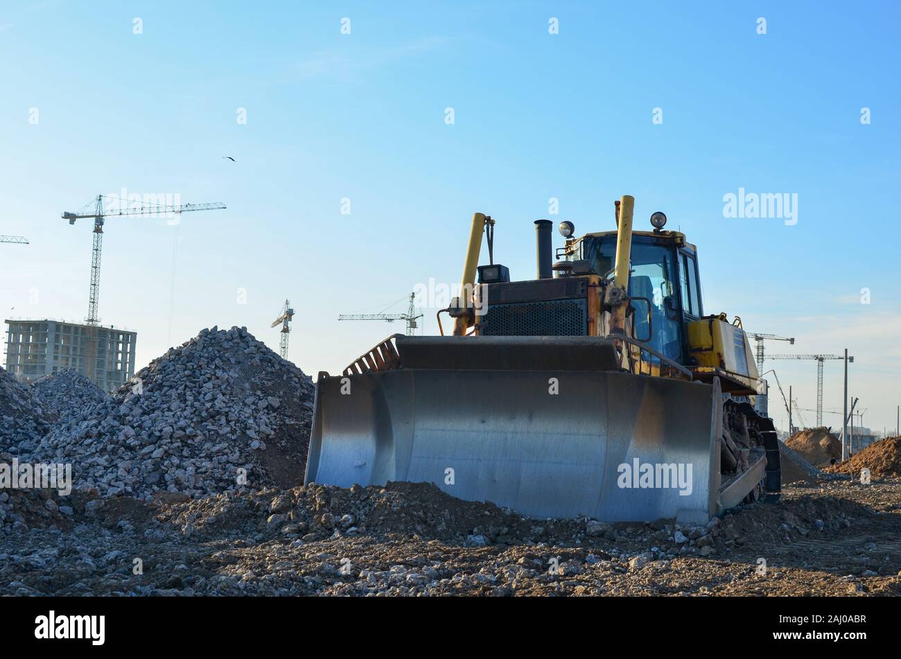 Bulldozer during of large construction jobs at building site. Land ...