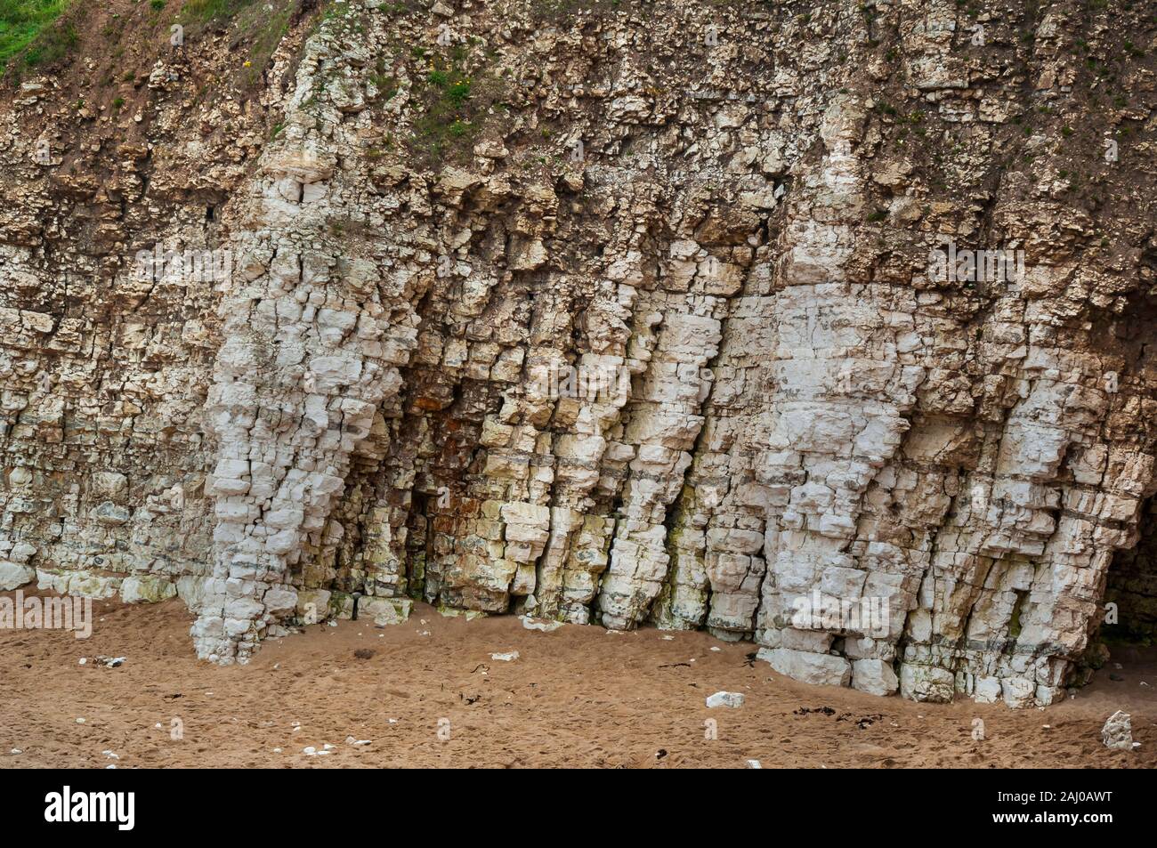 Chalk cliffs with tight vertical joints meeting the beach at North ...