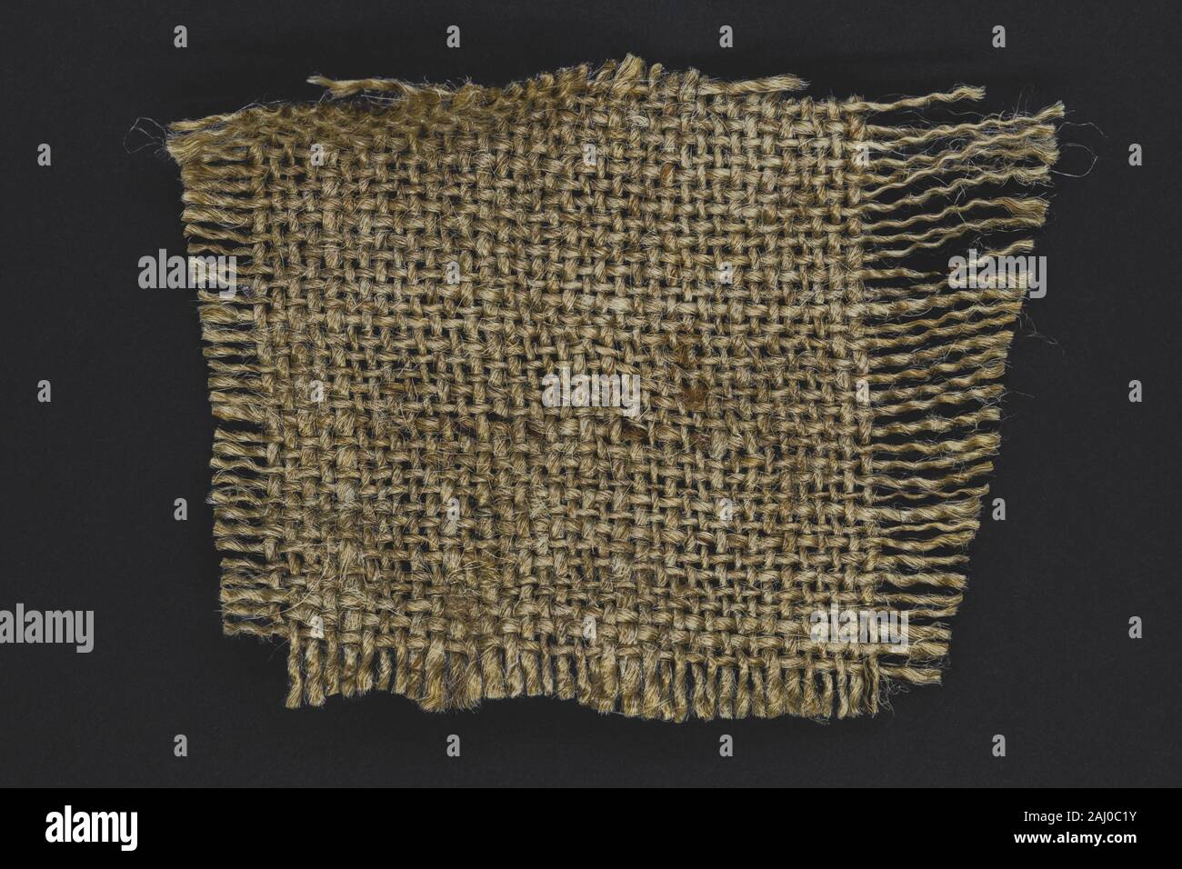 Linen beige canvas patch on black matte background surface Stock Photo ...