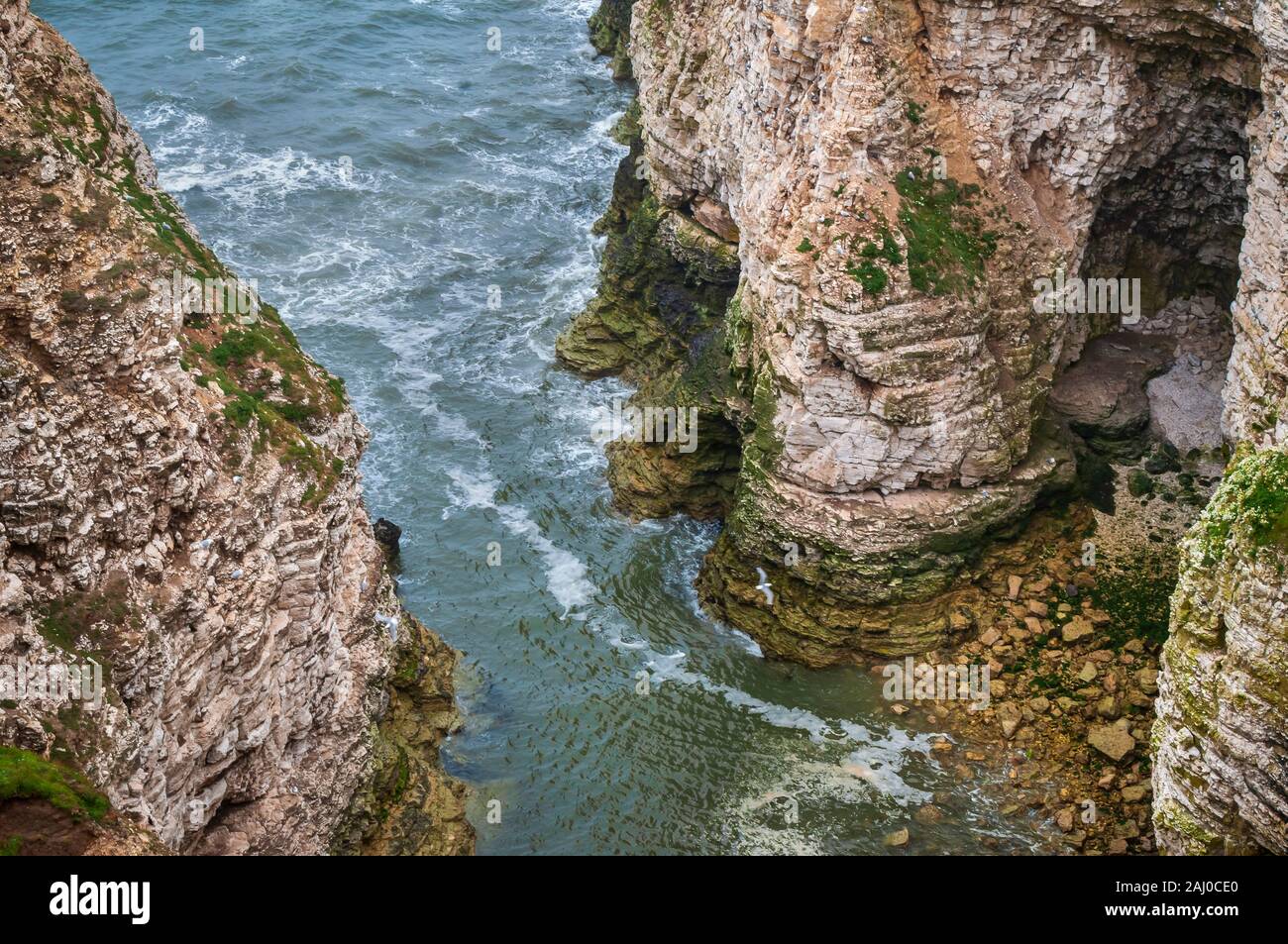 Eroded sea-caves at North Landing at Flamborough Head, Humberside ...