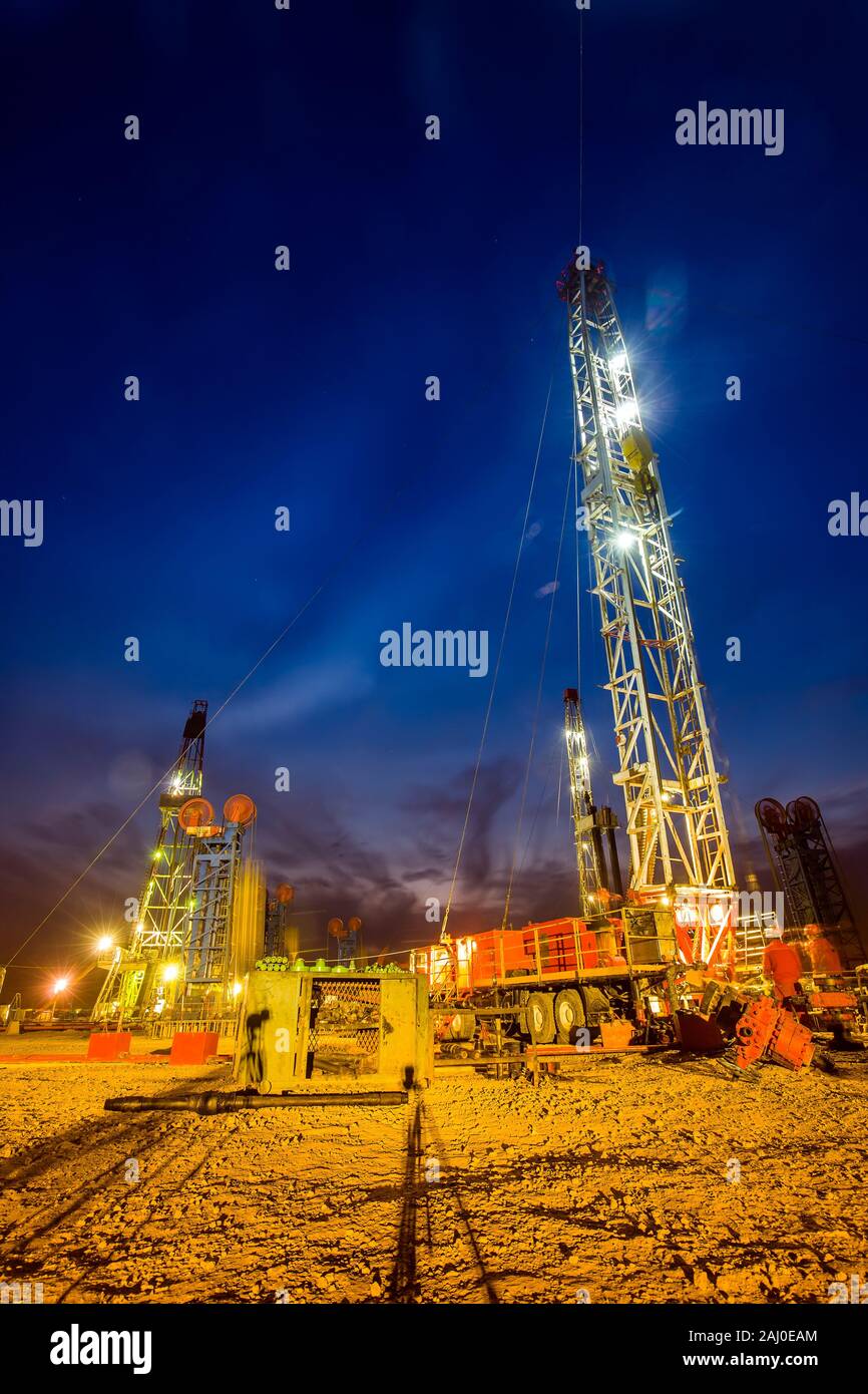 In the evening of oilfield derrick Stock Photo - Alamy