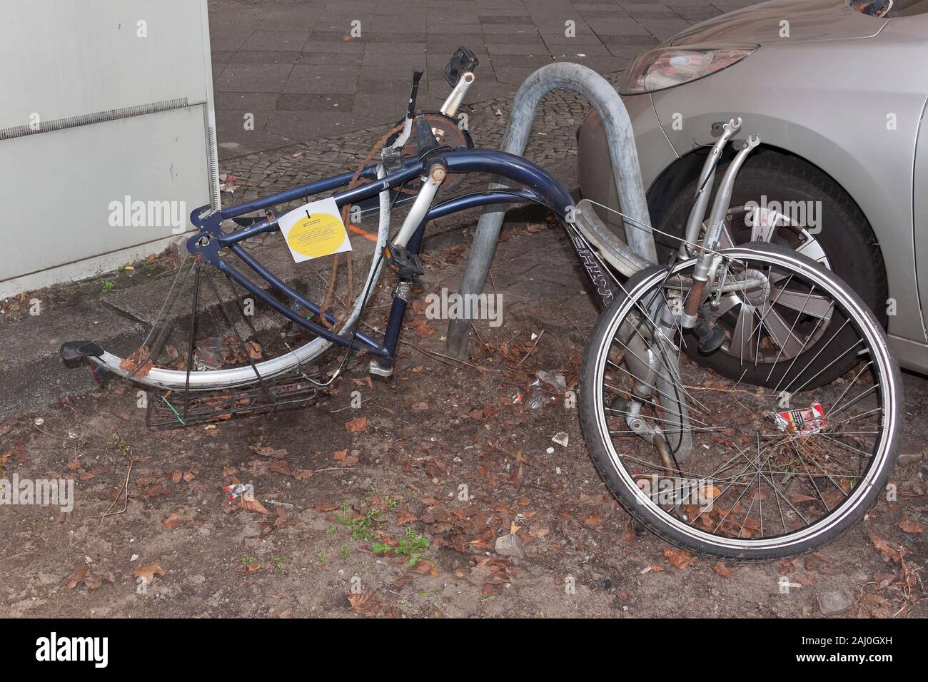 Defective bike with a yellow sign from the regulatory office in Berlin Stock Photo - Alamy