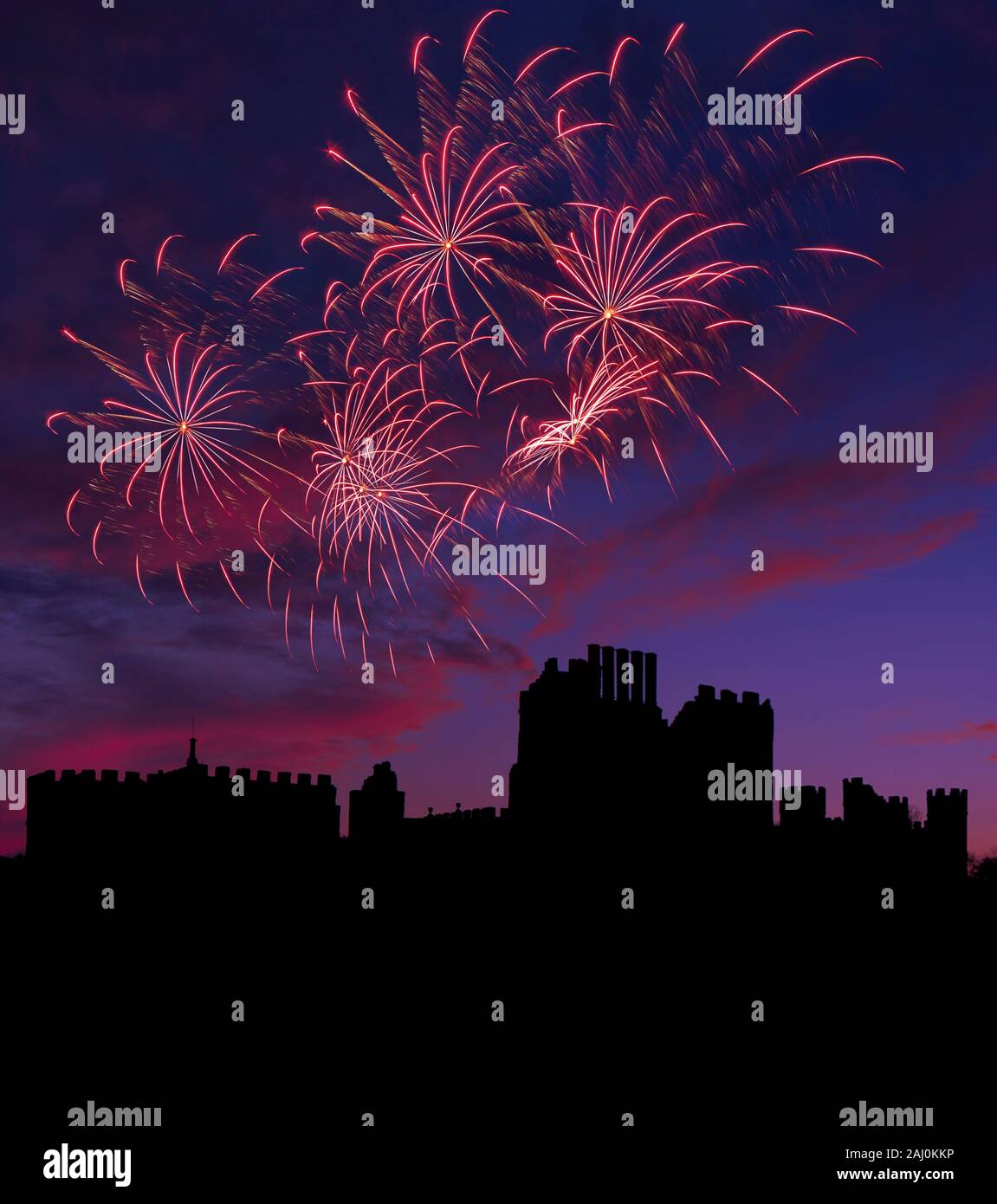 Fireworks over rooftops at sunset Stock Photo - Alamy